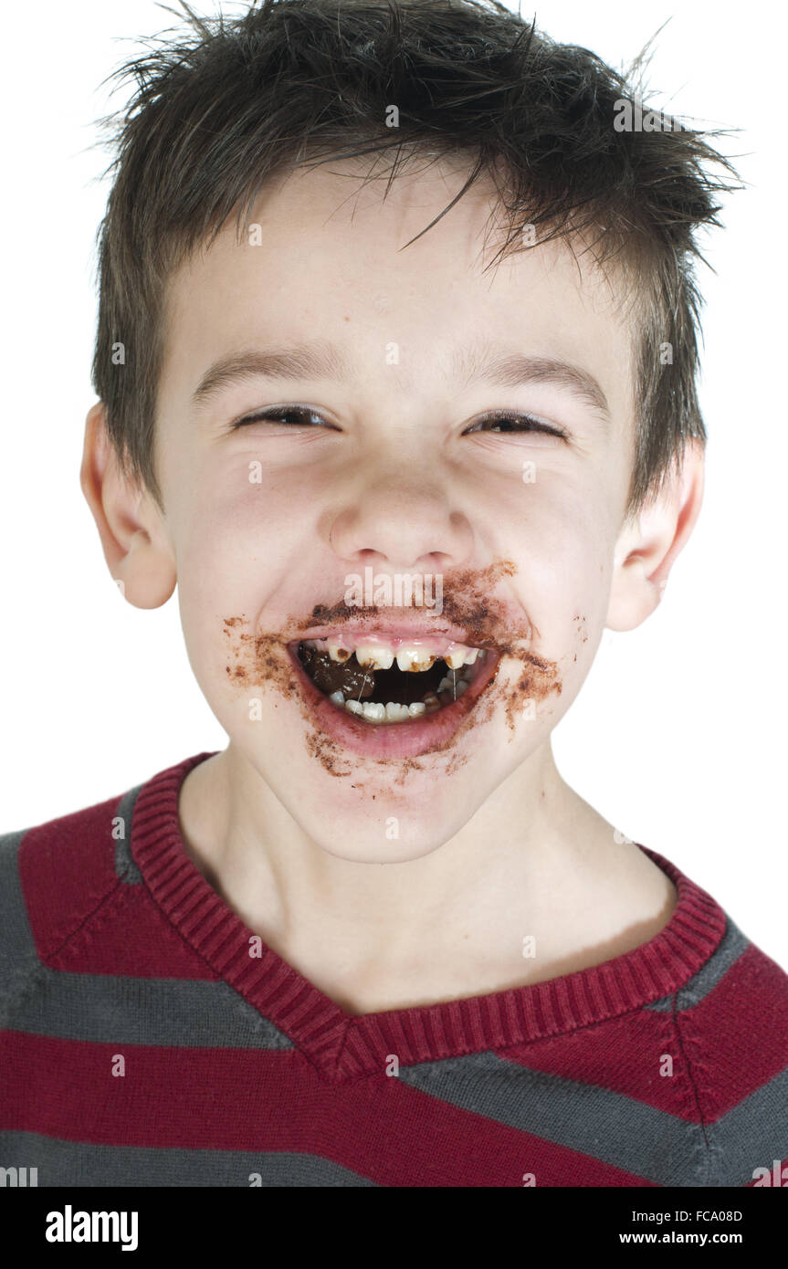 Smiling little boy eating chocolate Stock Photo - Alamy