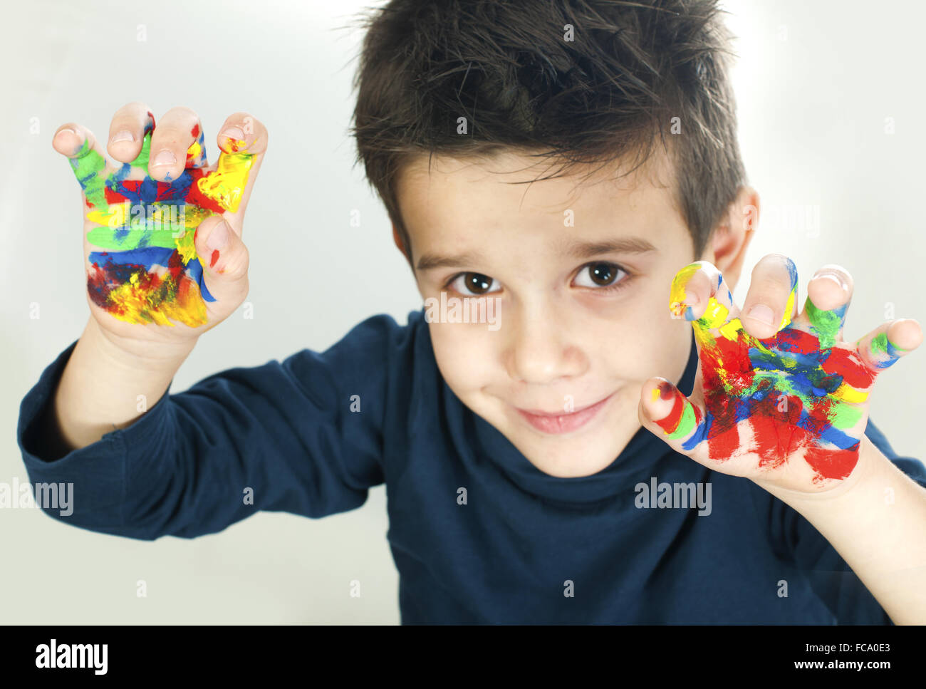Boy hands painted with colorful paint Stock Photo - Alamy