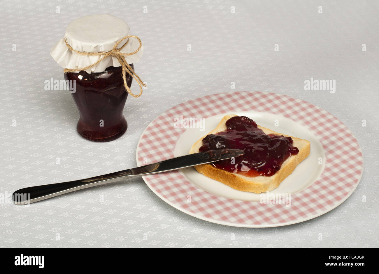 Spread jam on bread Stock Photo - Alamy