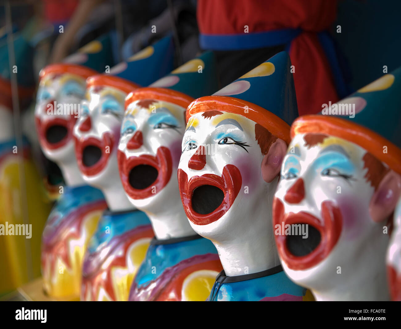 Line of ceramic clown head with open mouths at a game at the Canadian ...