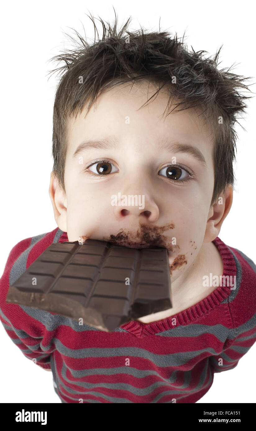 Smiling little boy eating chocolate Stock Photo - Alamy