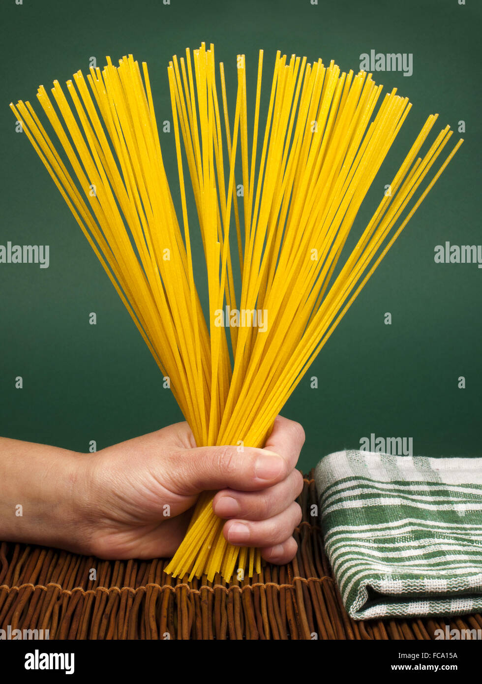 Female hand holding spaghetti Stock Photo - Alamy