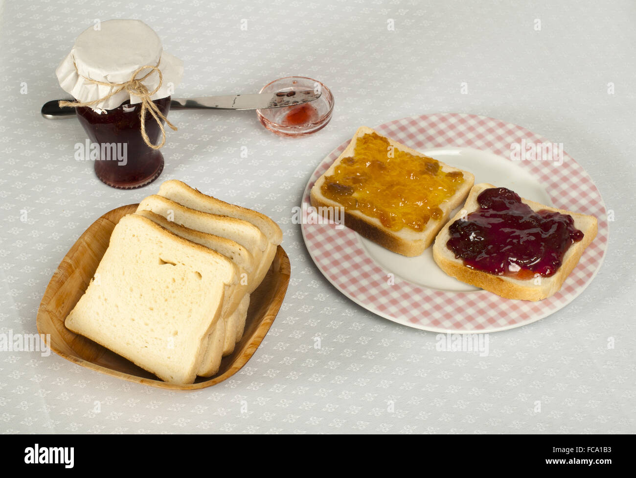 Spread jam on bread Stock Photo - Alamy