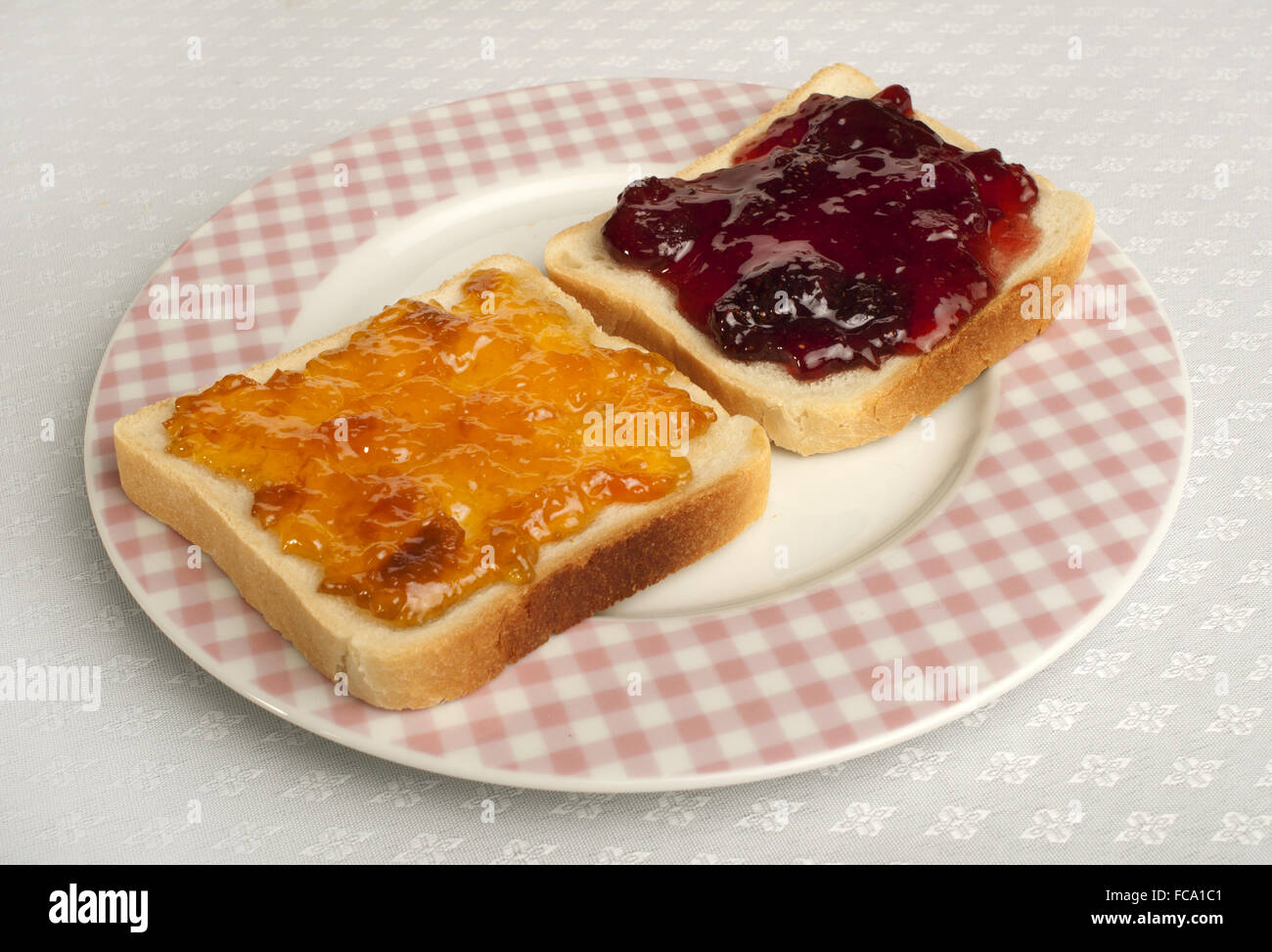 Spread jam on bread Stock Photo - Alamy