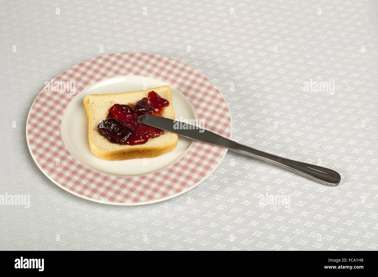 Spread jam on bread Stock Photo - Alamy