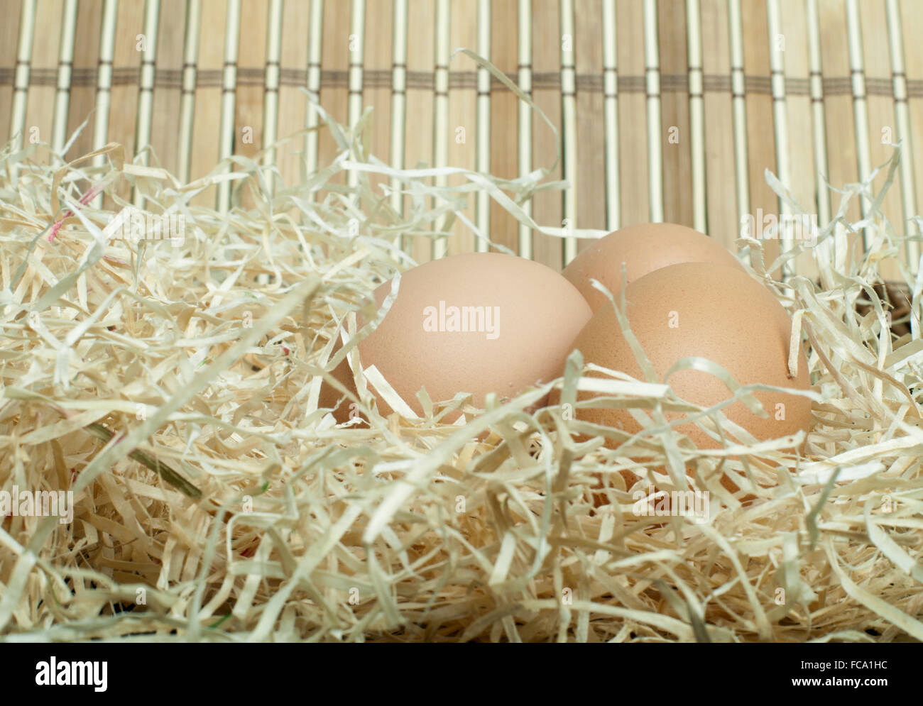 Raw eggs in straw Stock Photo - Alamy