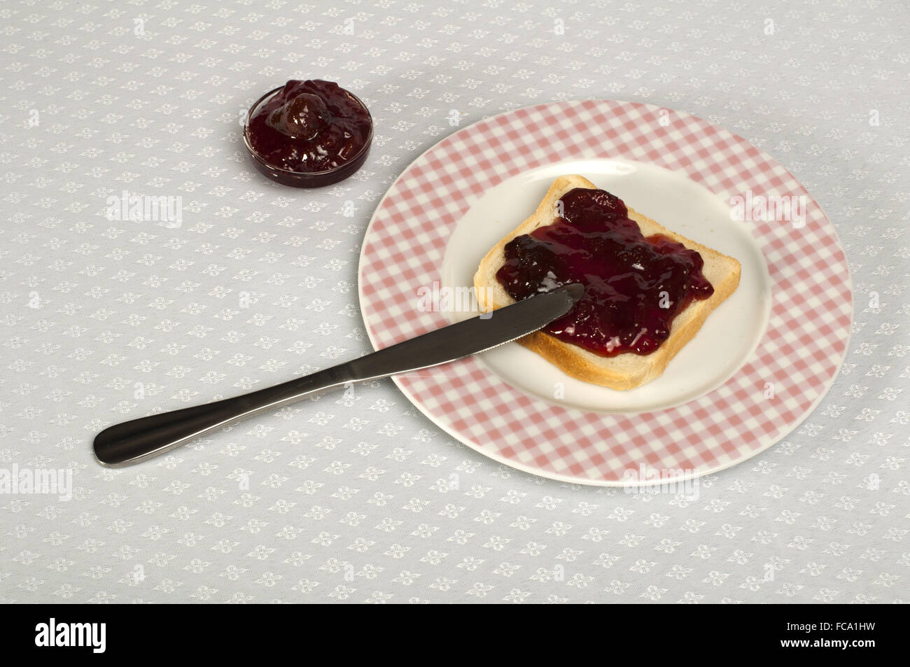 Spread jam on bread Stock Photo - Alamy