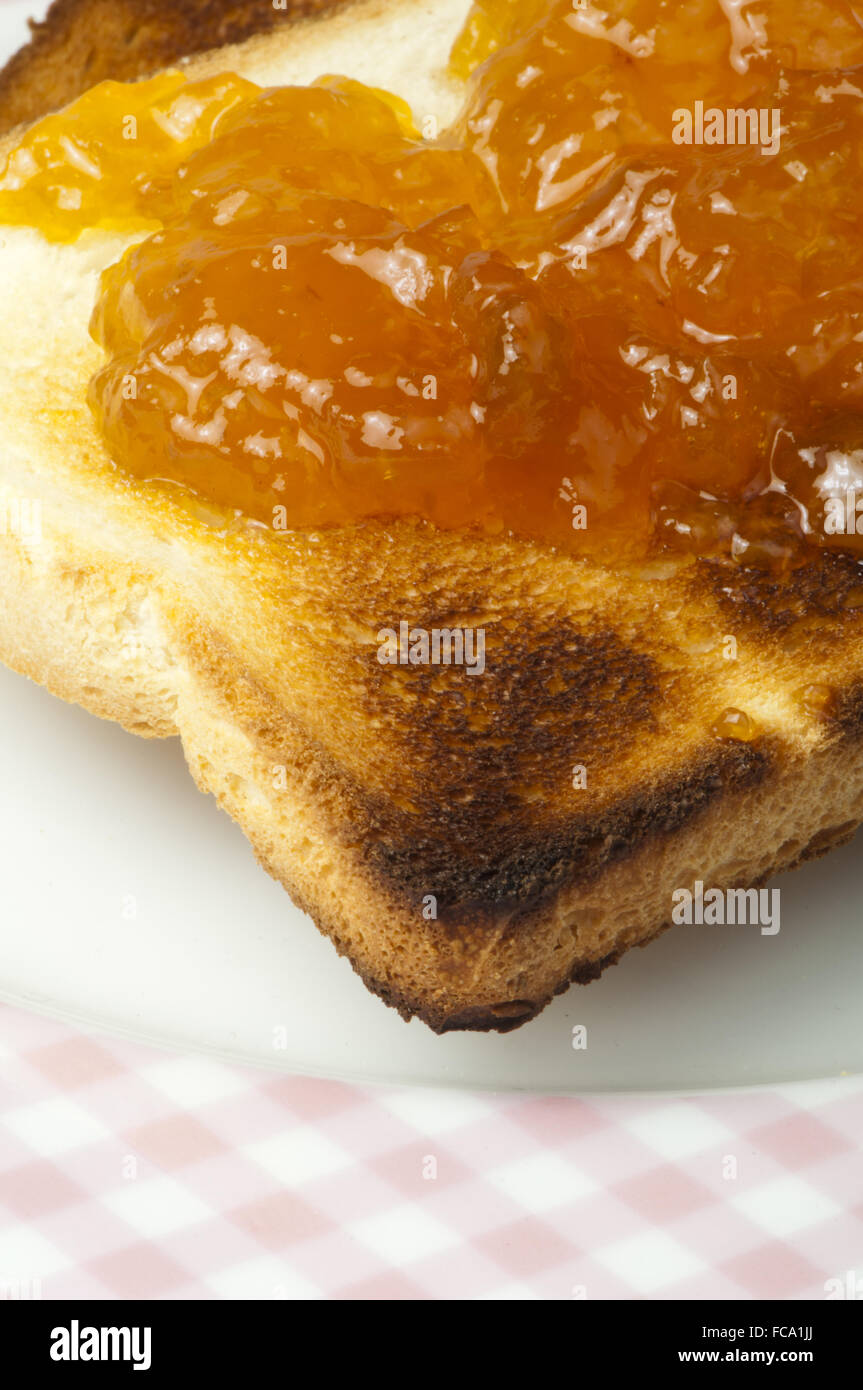 Spread jam on bread Stock Photo - Alamy