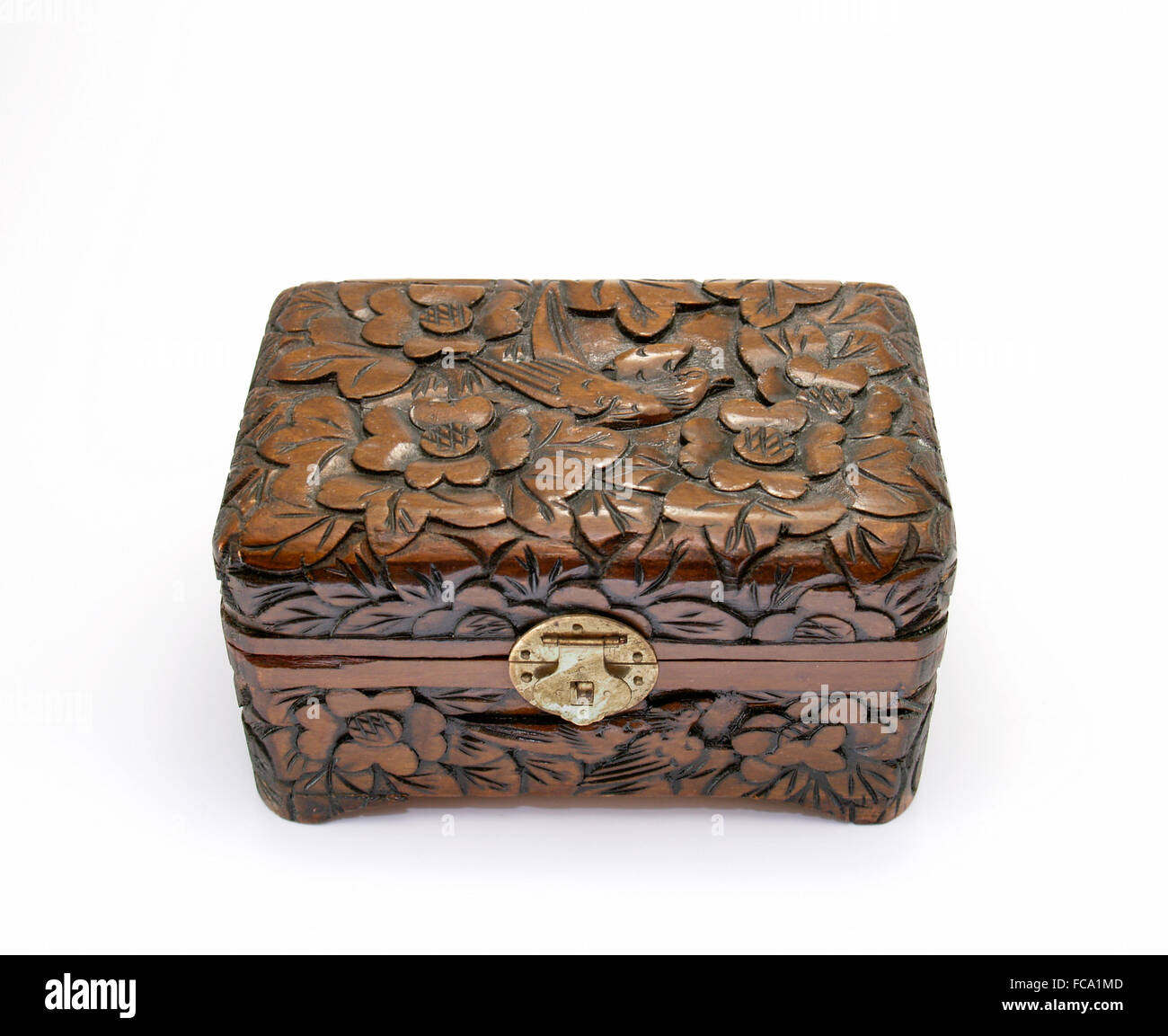 Brown wooden ornate box with flower carvings and gold clasp isolated on ...