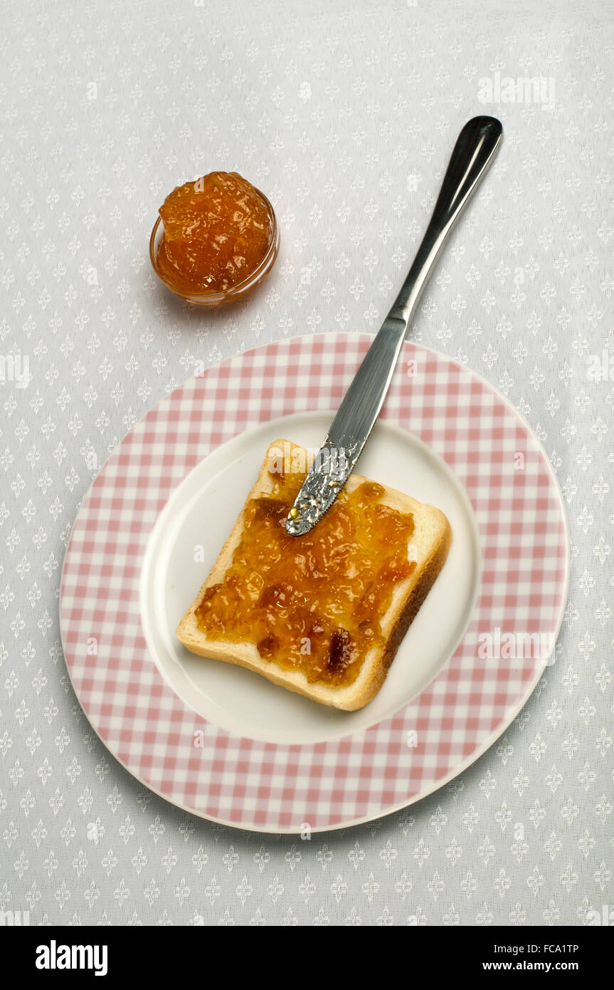 Spread jam on bread Stock Photo - Alamy