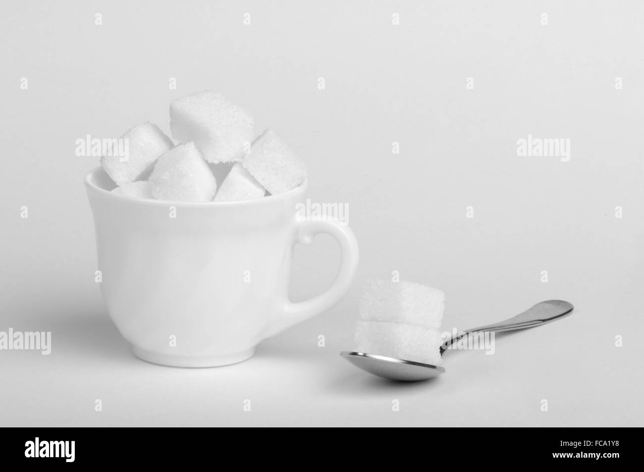 Sugar lumps in cup Stock Photo - Alamy