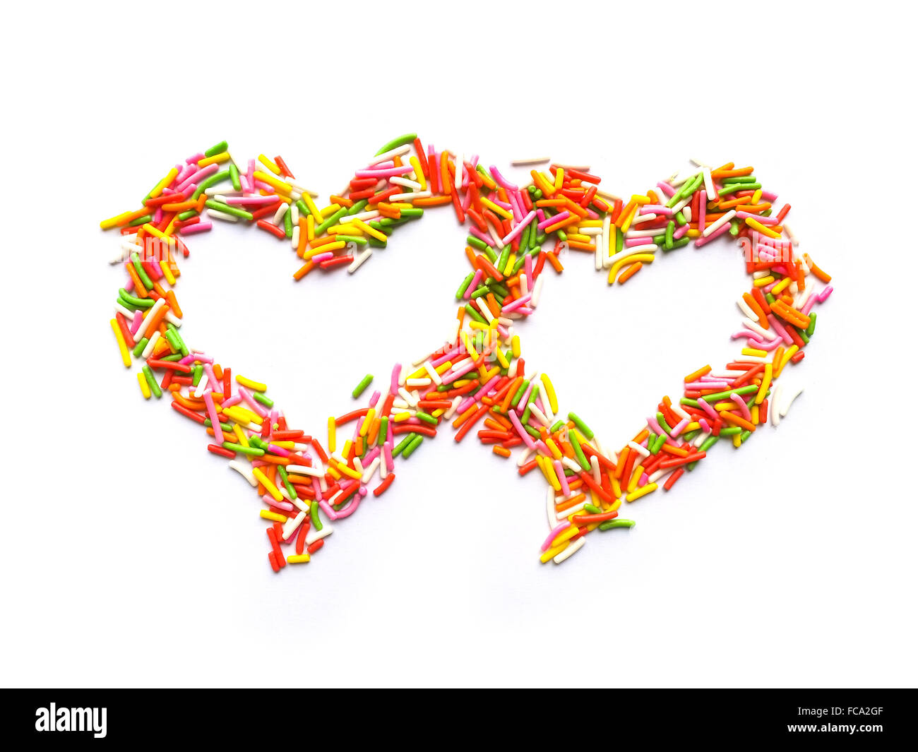 Valentine sweet sprinkle hearts on white background Stock Photo - Alamy