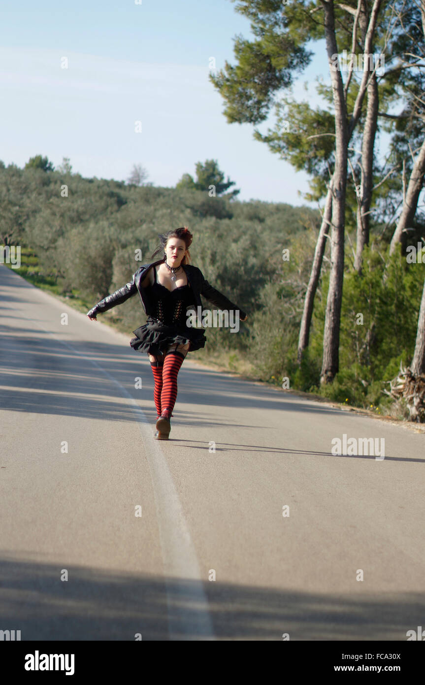 Girl running on the road Stock Photo - Alamy