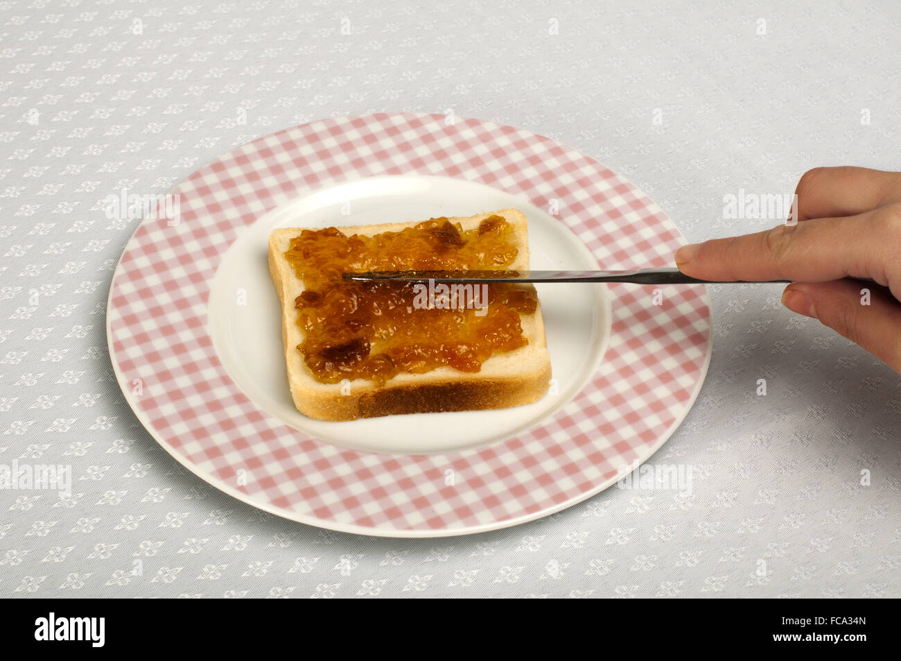 Spread jam on bread Stock Photo - Alamy