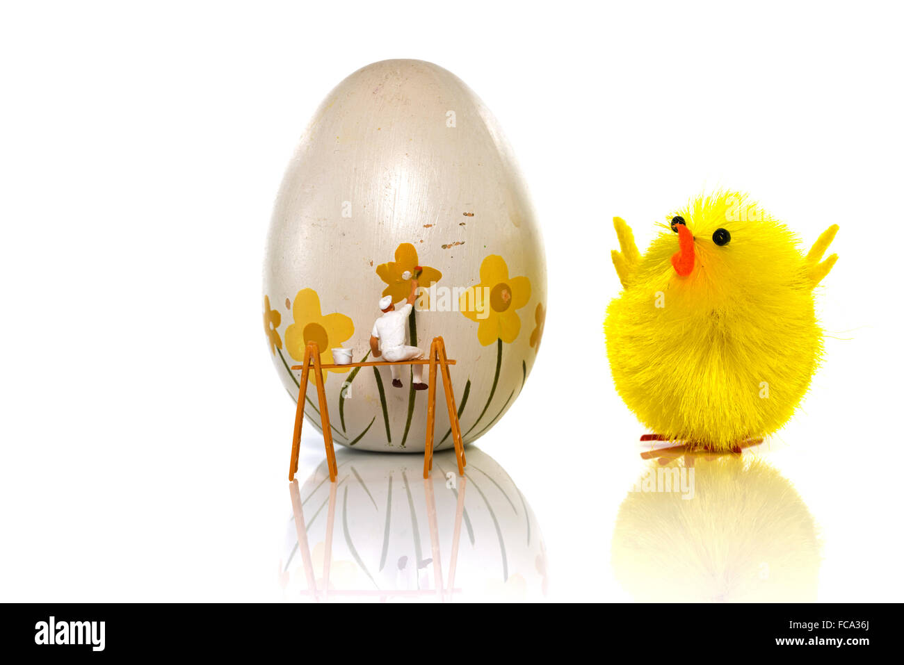 little world puppet painting easter egg with yellow chicken wath Stock ...