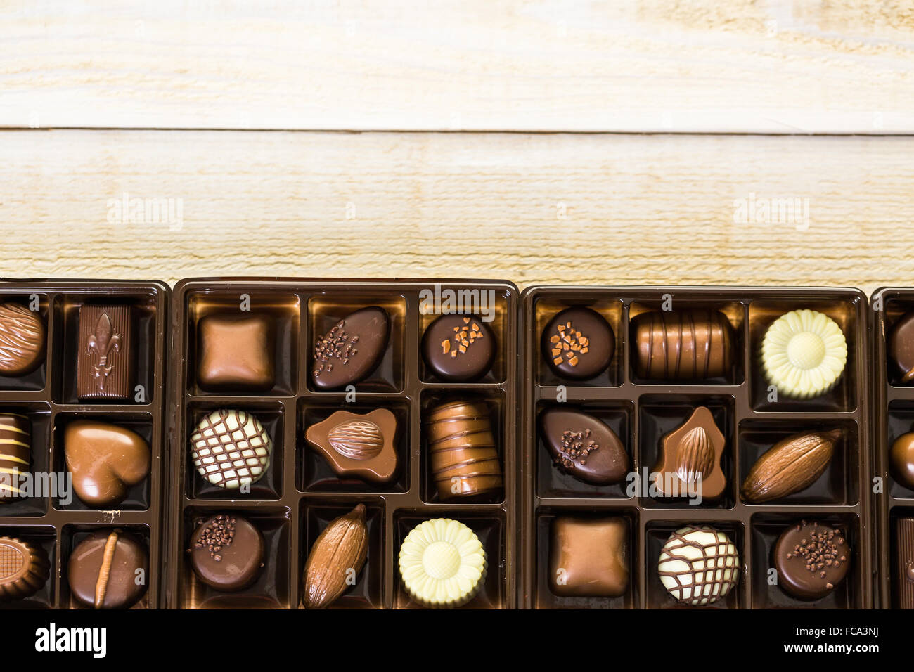 Assorted chocolates on wood table Stock Photo - Alamy