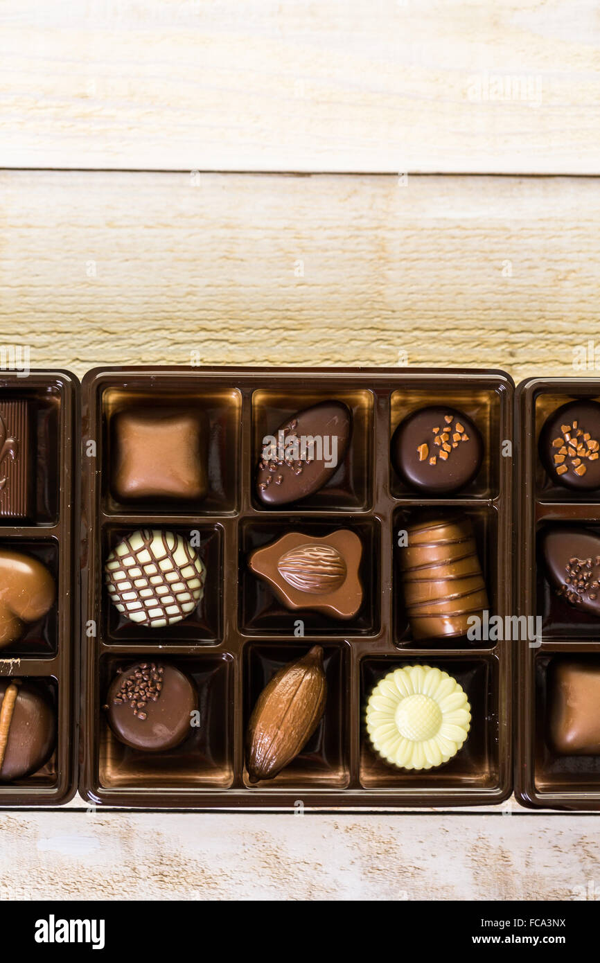 Assorted chocolates on wood table Stock Photo - Alamy