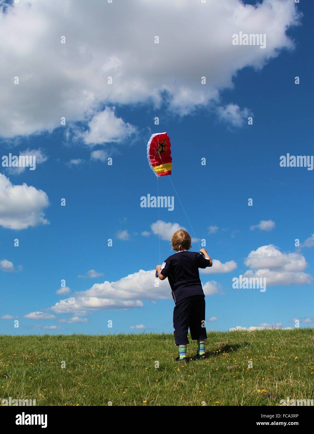 Child starts a kite Stock Photo - Alamy