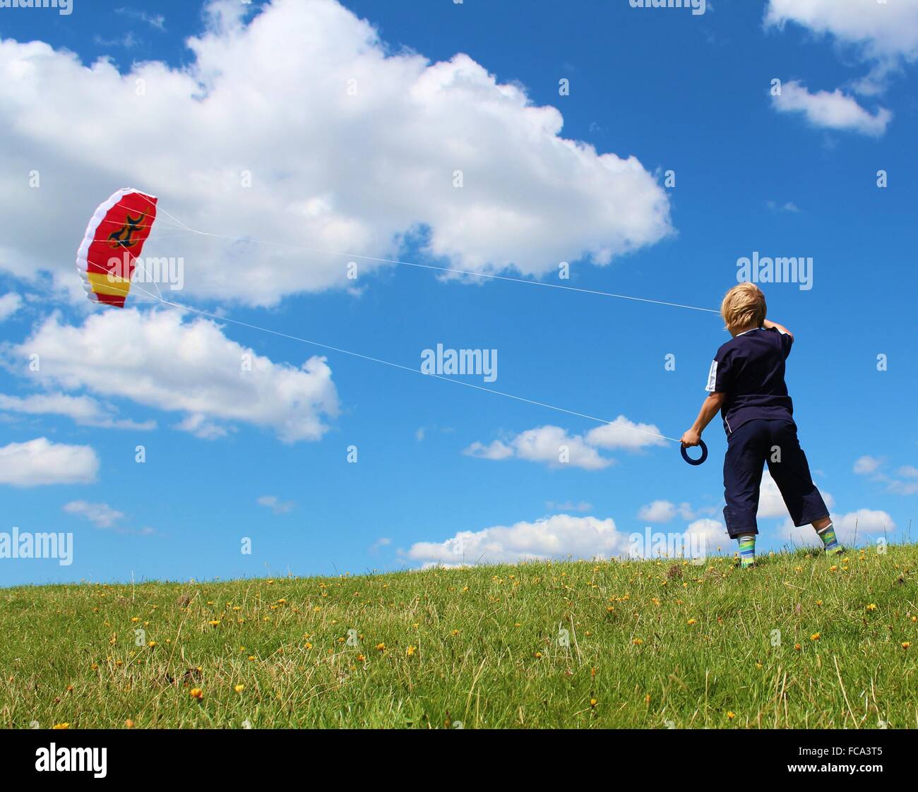 Child starts a kite Stock Photo - Alamy