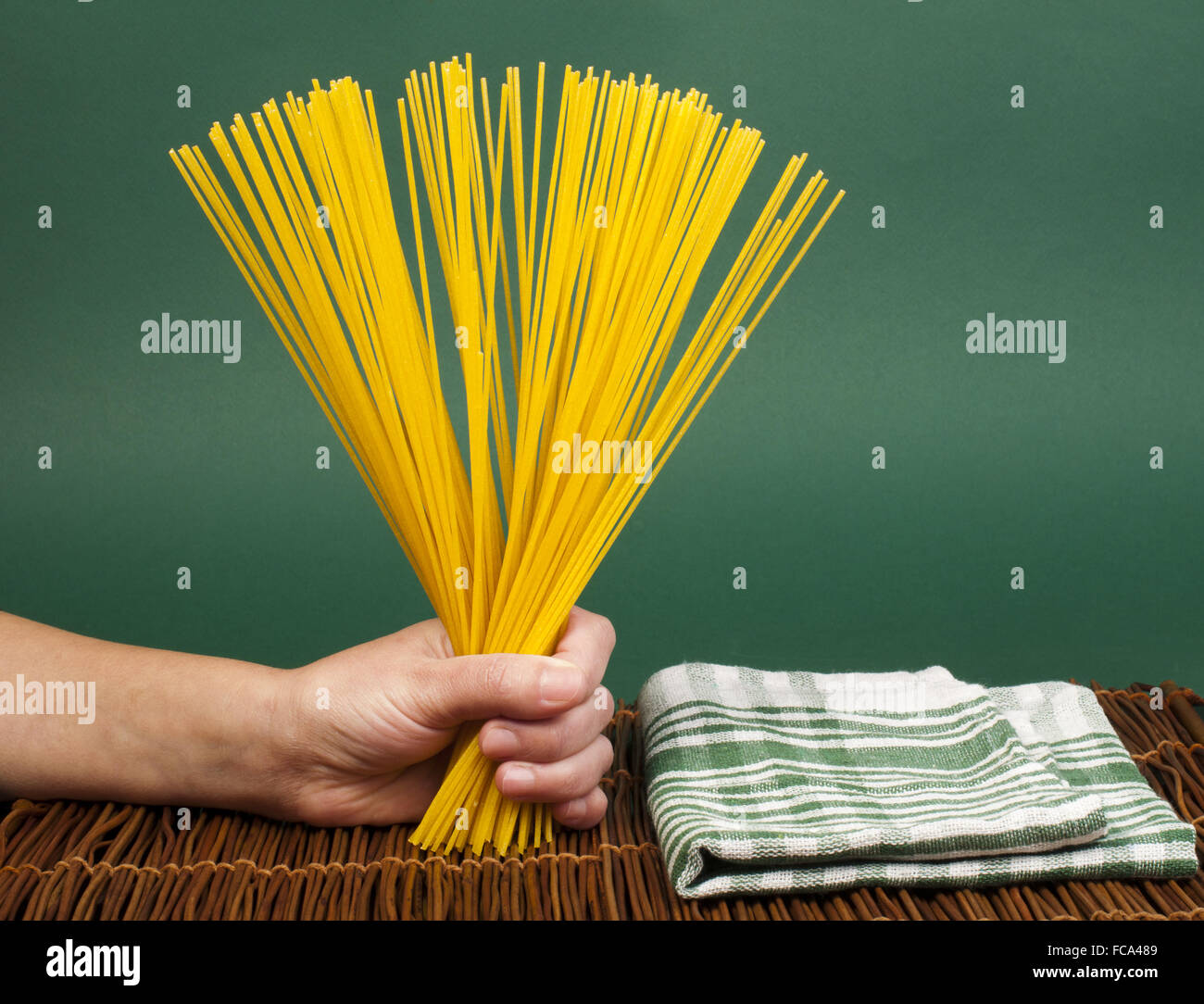 Female hand holding spaghetti Stock Photo - Alamy