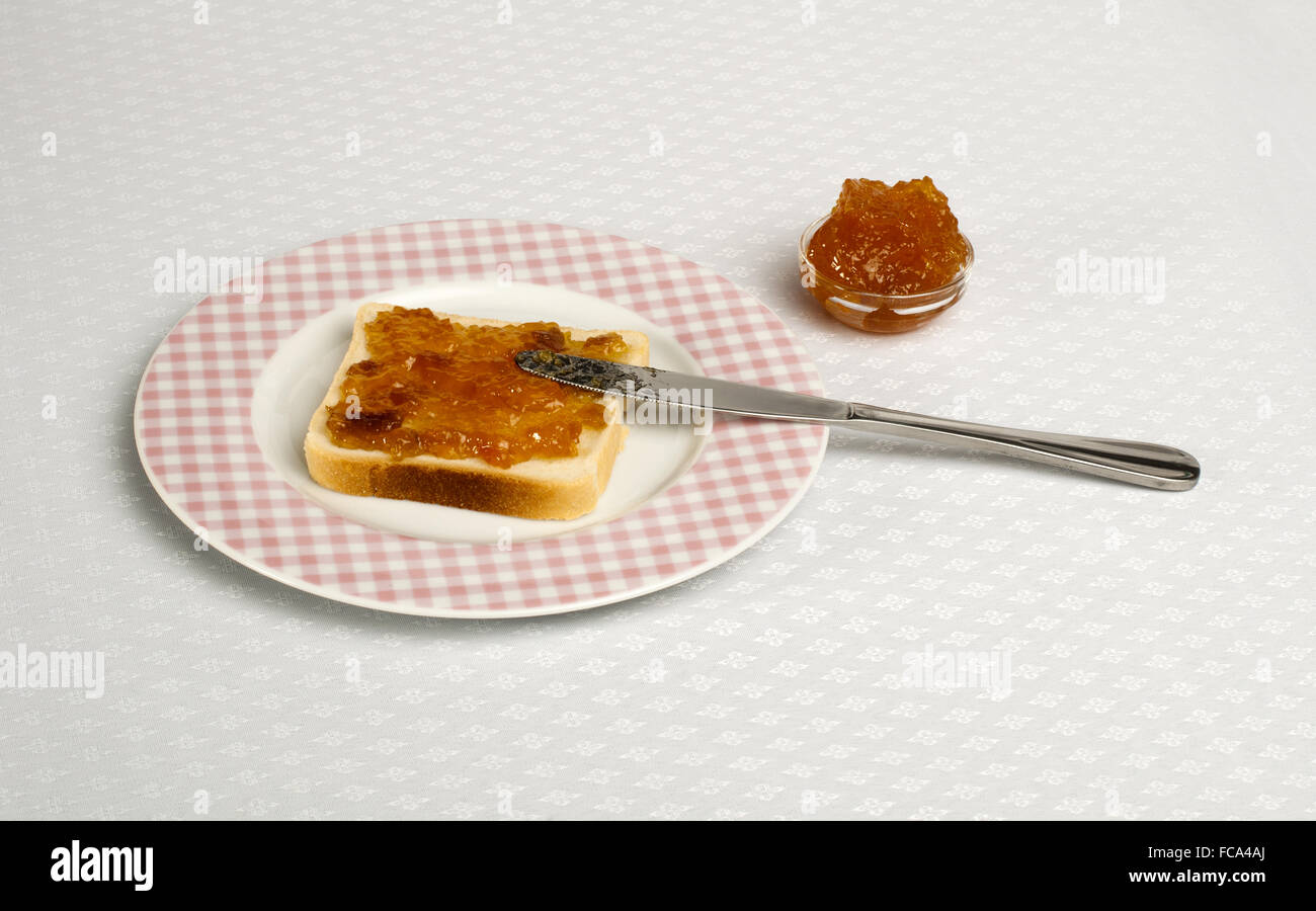 Spread jam on bread Stock Photo - Alamy