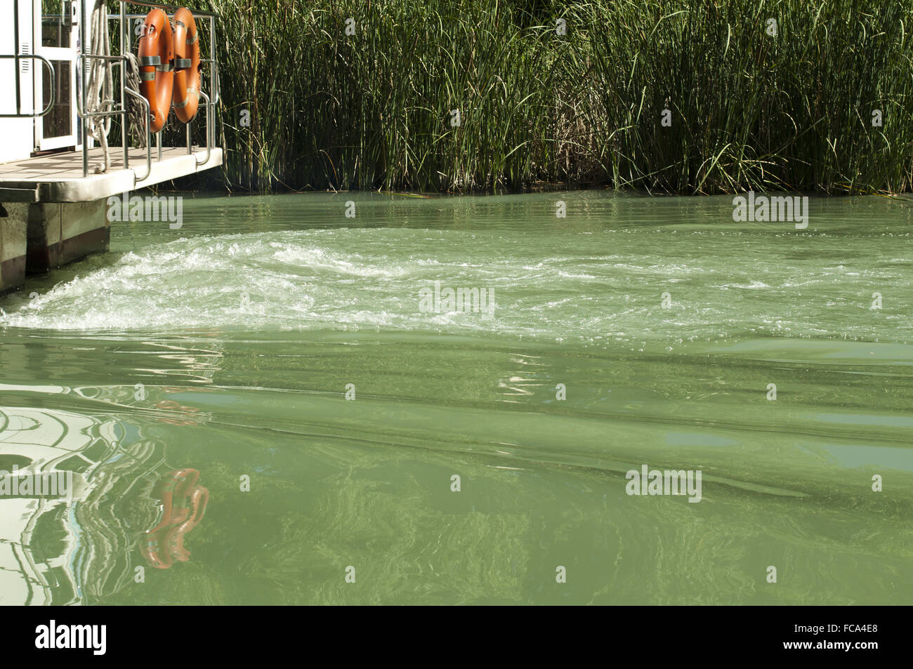 Tourist boat floating on river Stock Photo - Alamy
