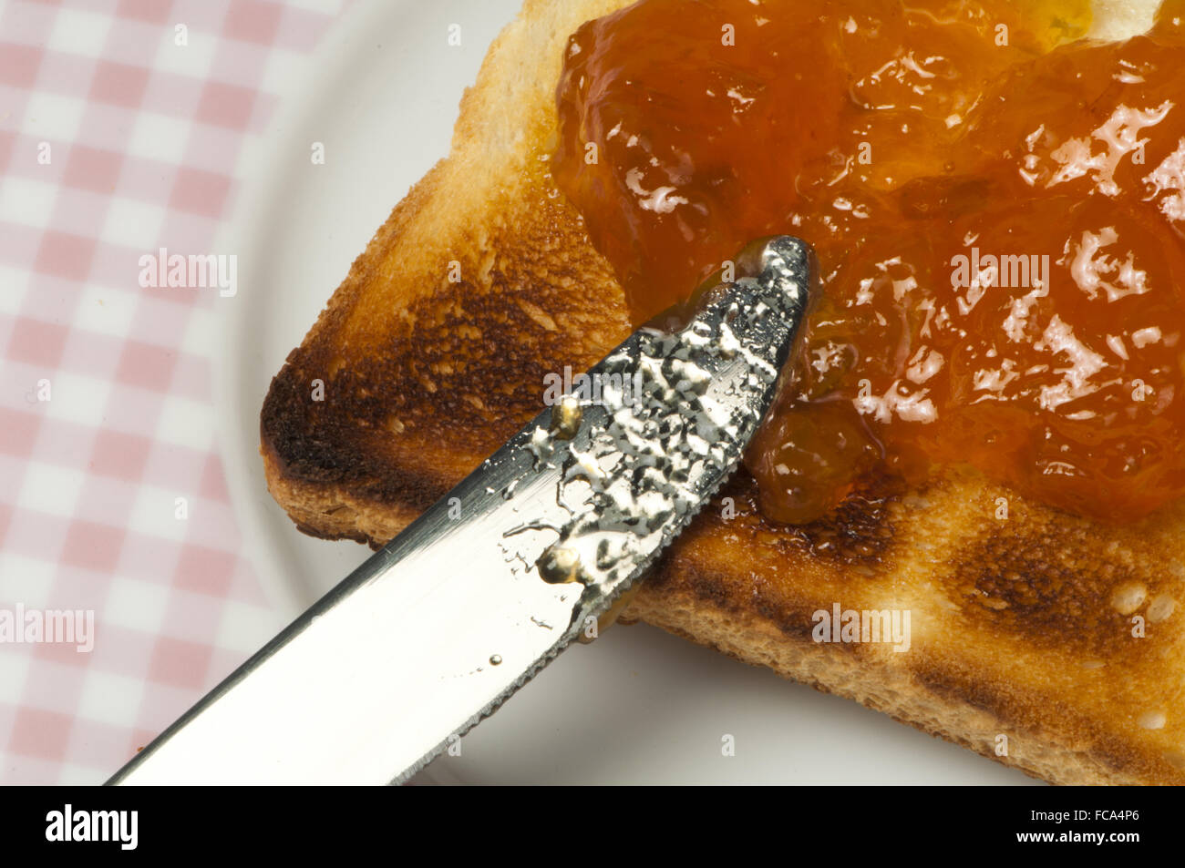 Spread jam on bread Stock Photo - Alamy