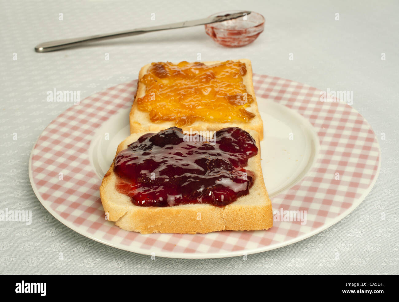 Spread jam on bread Stock Photo - Alamy