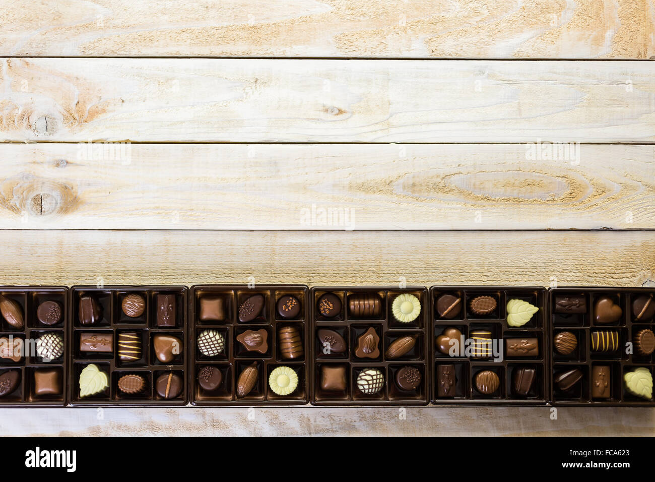 Assorted chocolates on wood table Stock Photo - Alamy