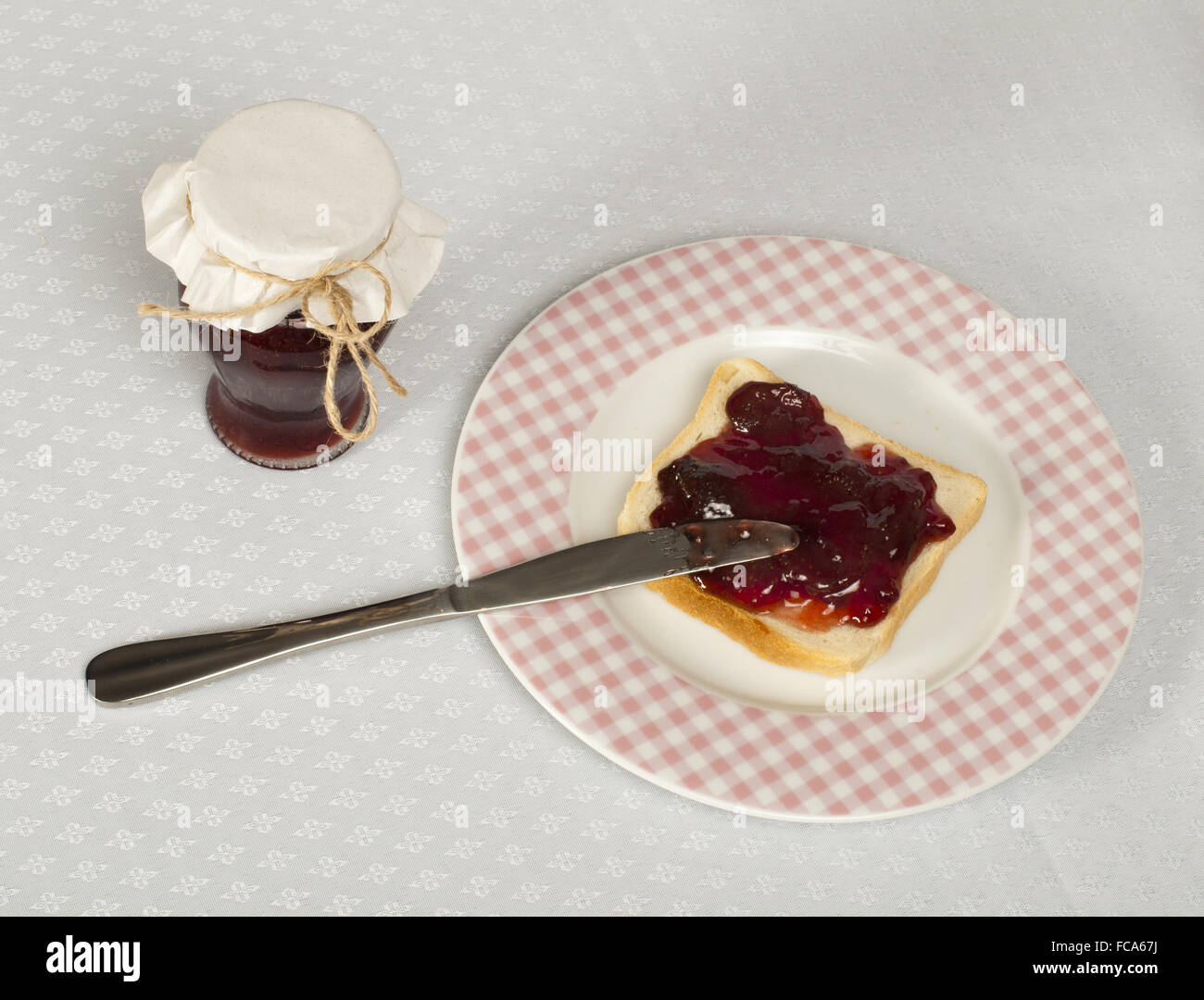 Spread jam on bread Stock Photo - Alamy
