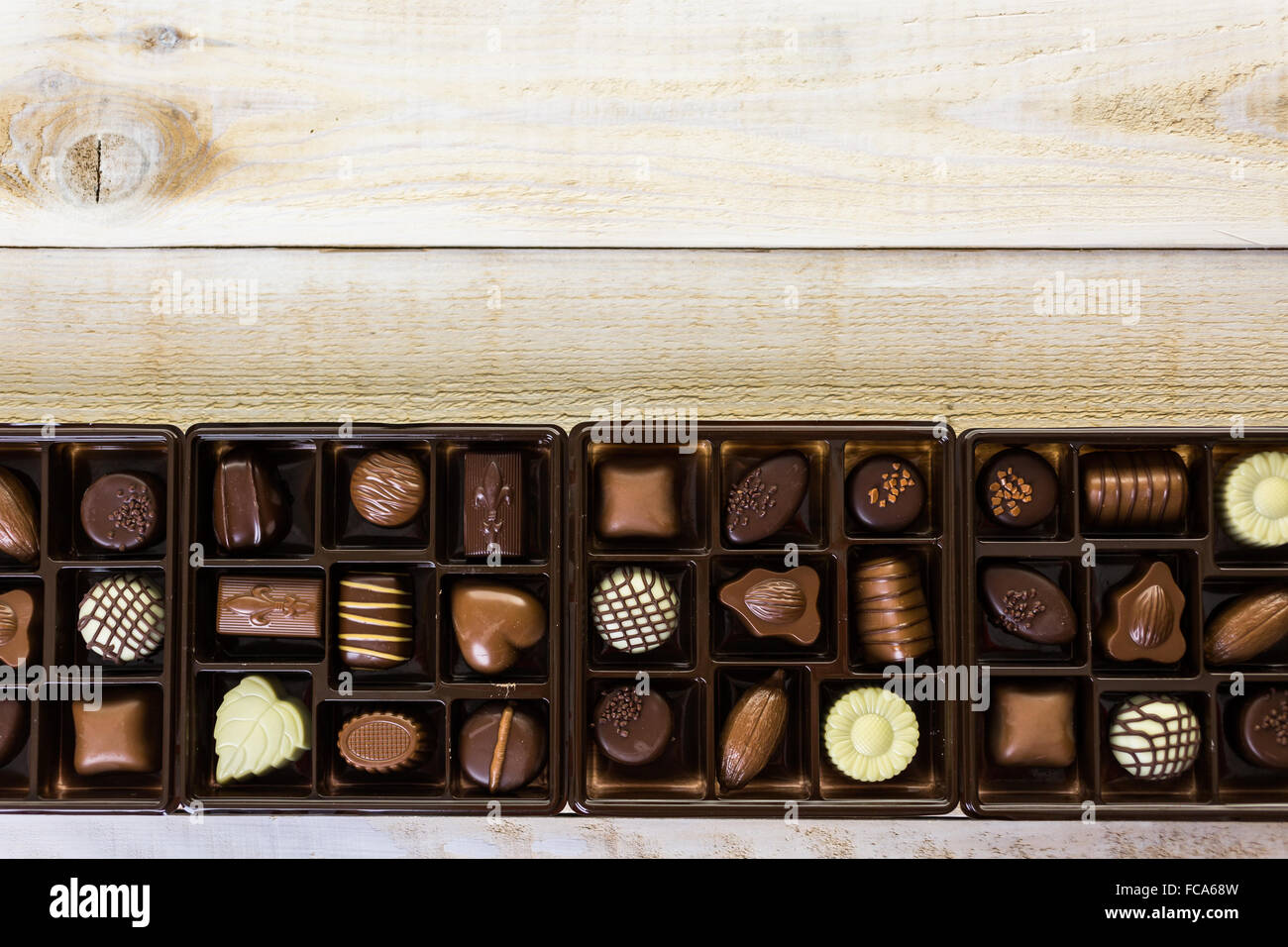 Assorted chocolates on wood table Stock Photo - Alamy