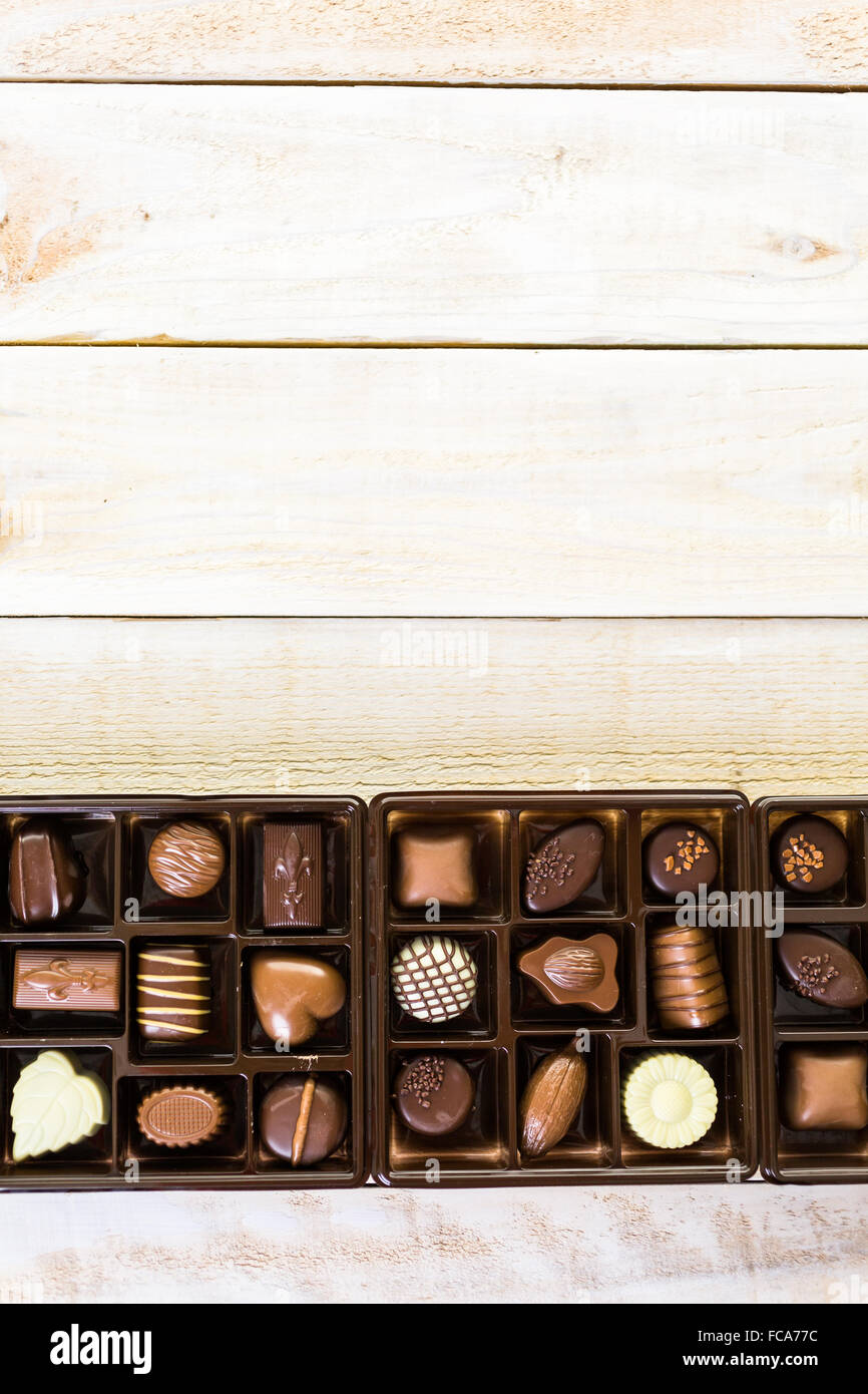 Assorted chocolates on wood table Stock Photo - Alamy