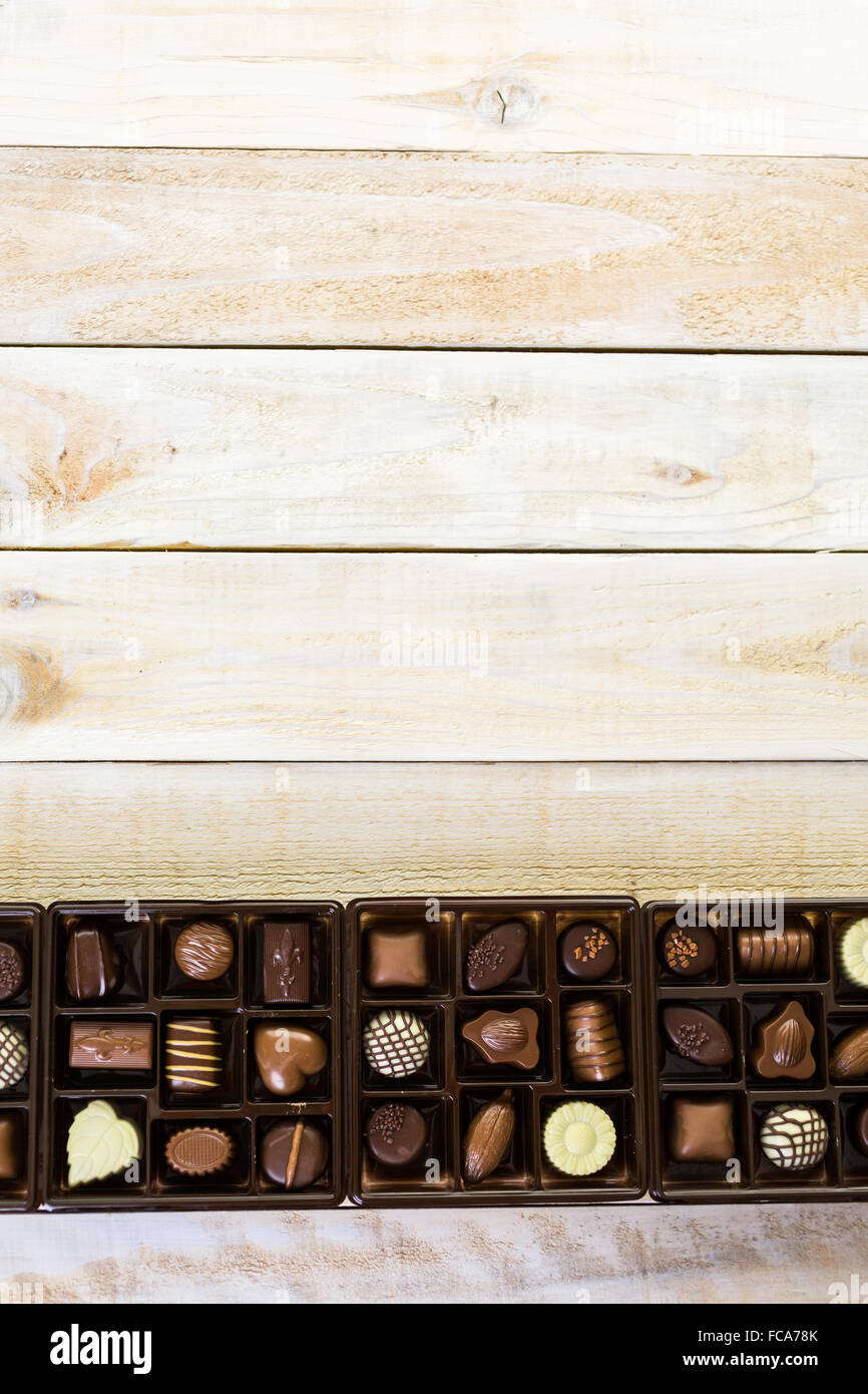 Assorted chocolates on wood table Stock Photo - Alamy