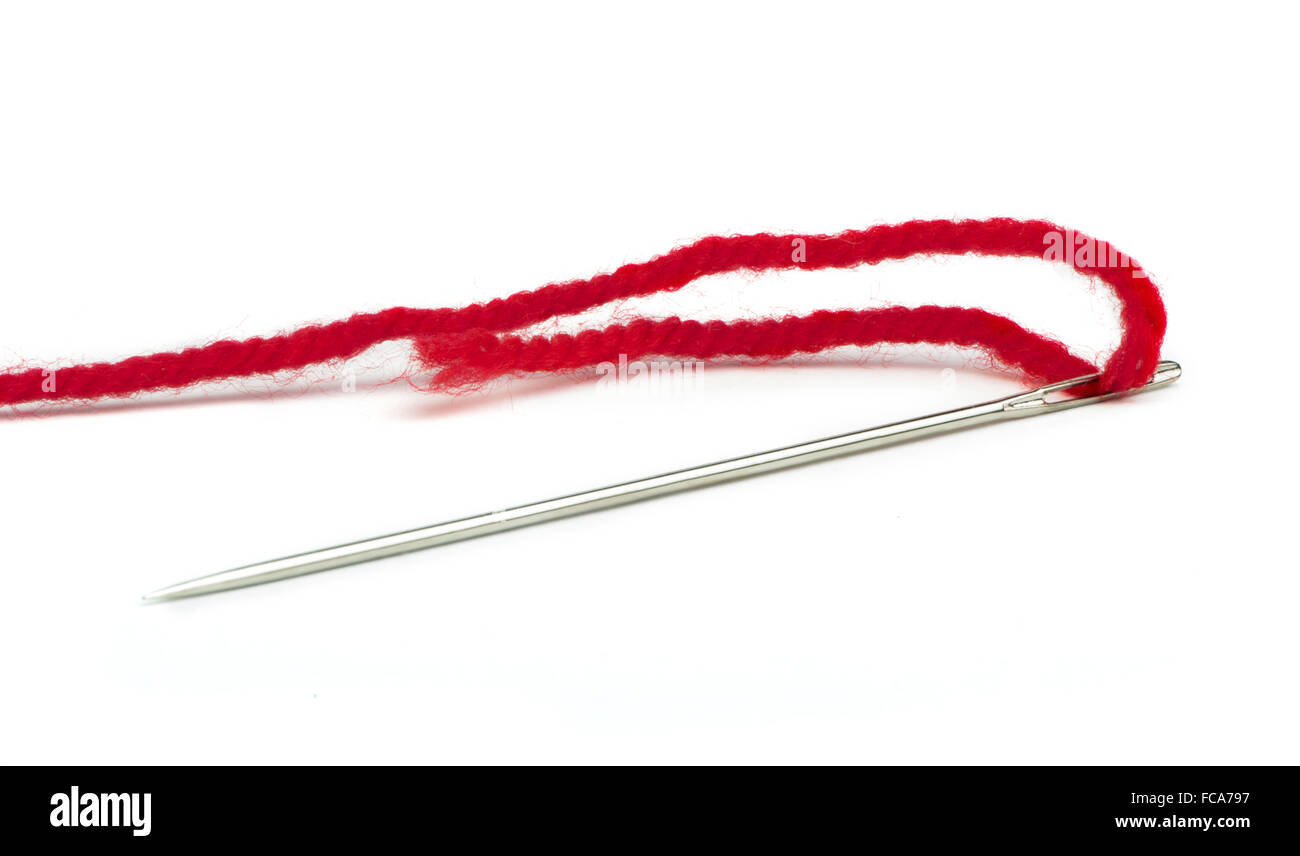Sewing needle and red thread Stock Photo - Alamy