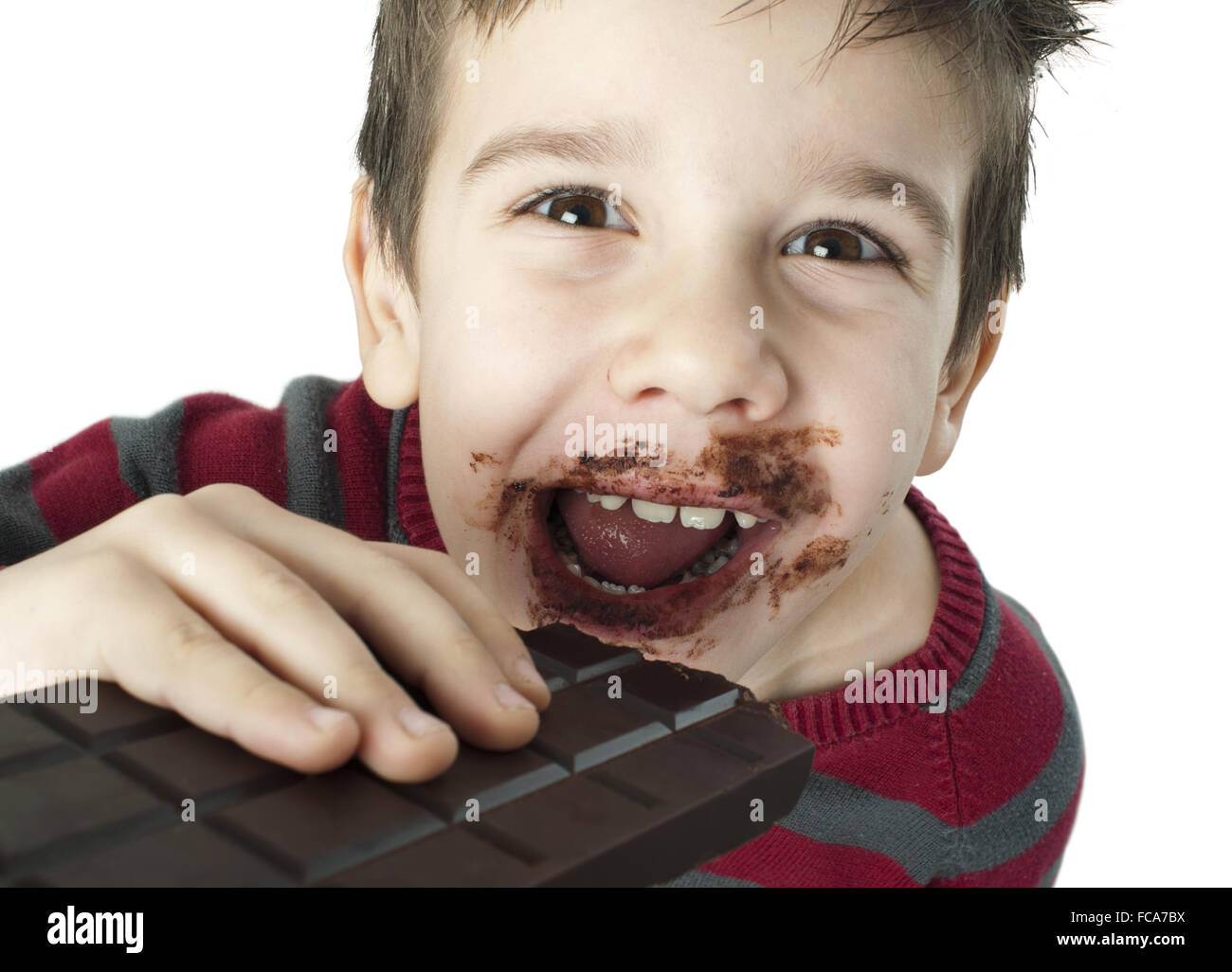 Smiling little boy eating chocolate Stock Photo - Alamy