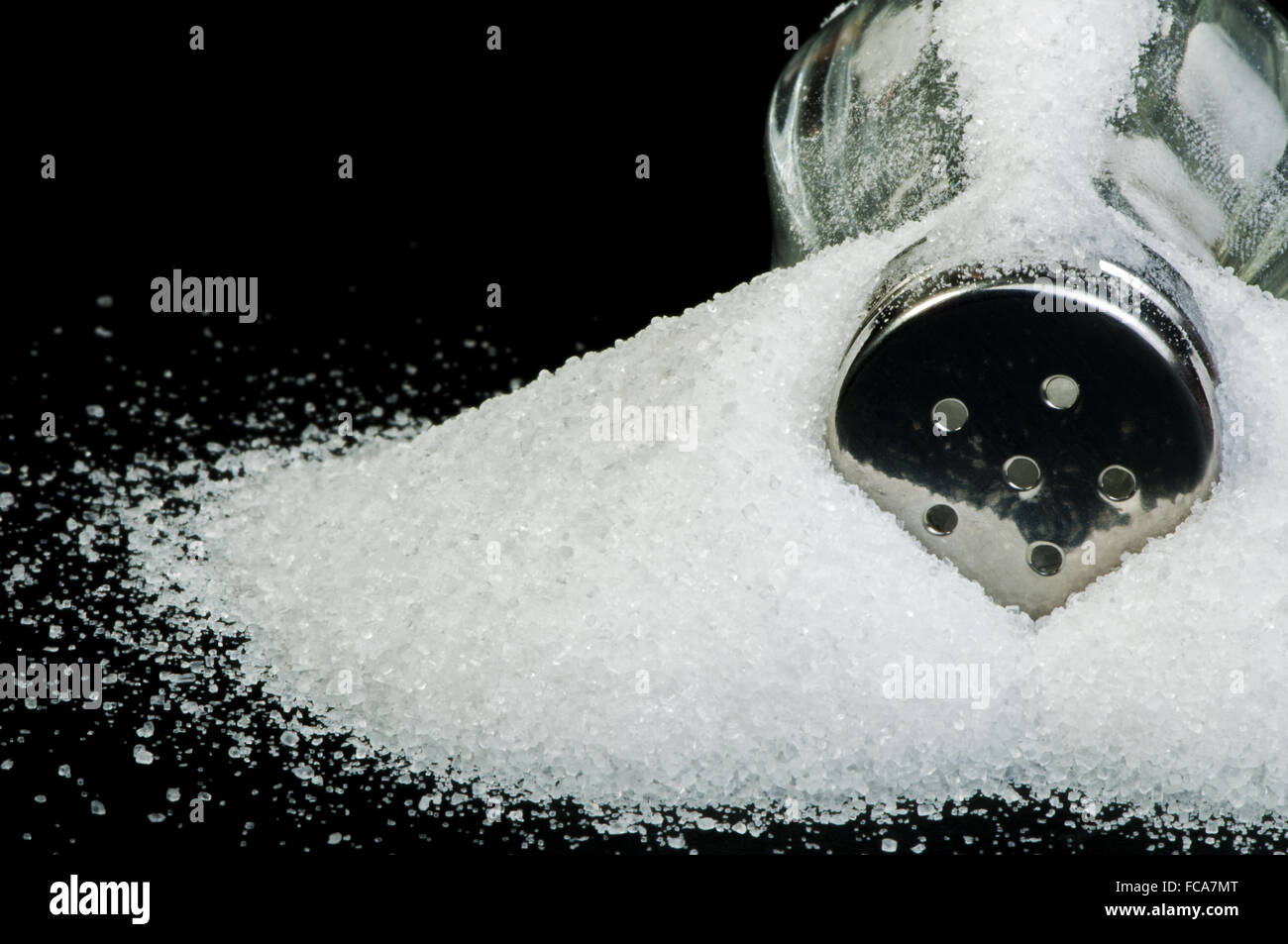 Salt on black background Stock Photo - Alamy