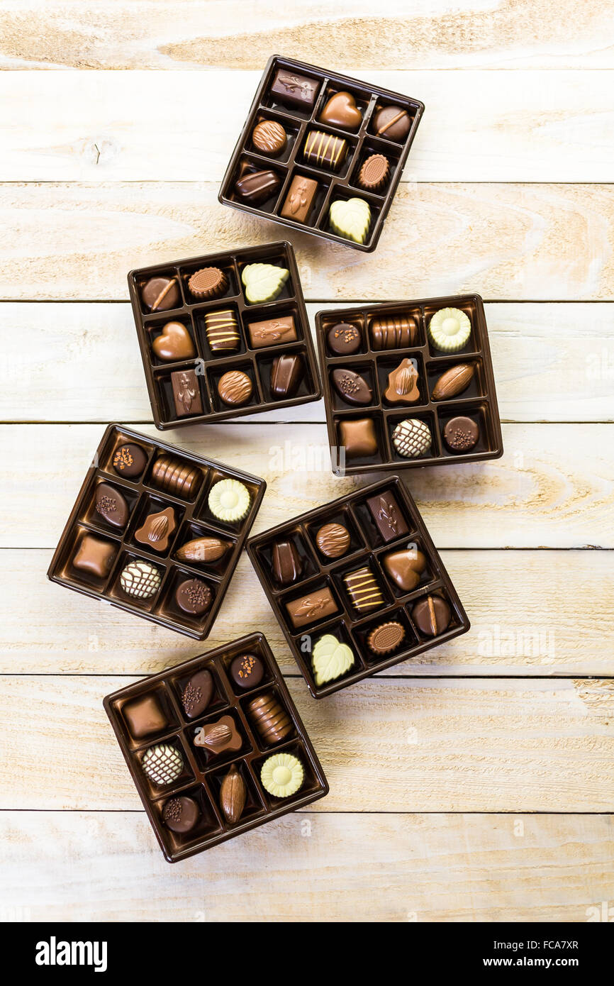 Assorted chocolates on wood table Stock Photo - Alamy