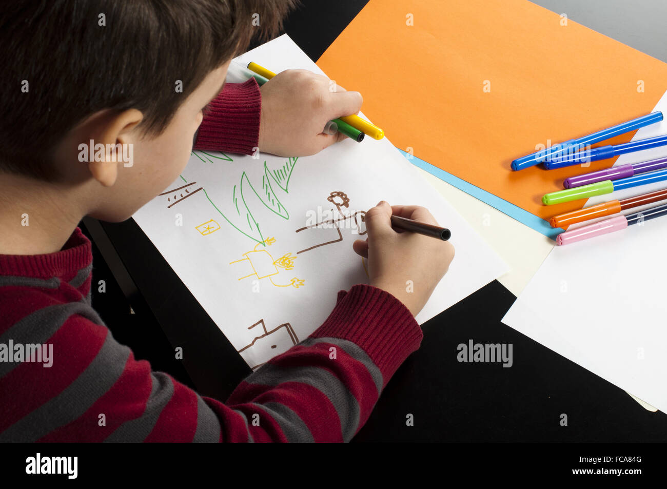 Boy drawing with markers Stock Photo - Alamy
