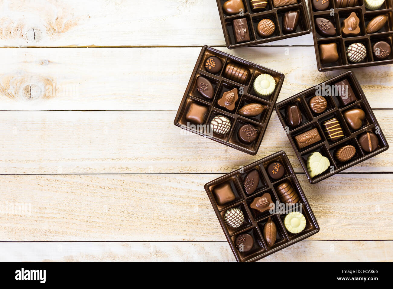 Assorted chocolates on wood table Stock Photo - Alamy