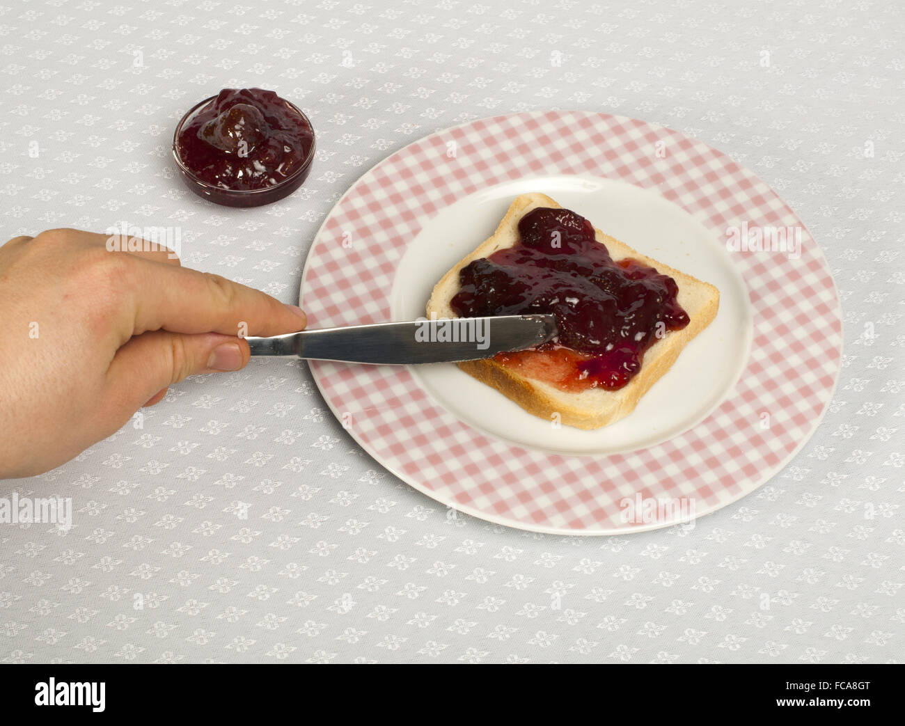 Spread jam on bread Stock Photo - Alamy