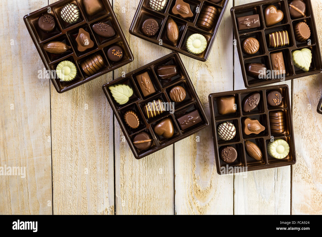 Assorted chocolates on wood table Stock Photo - Alamy