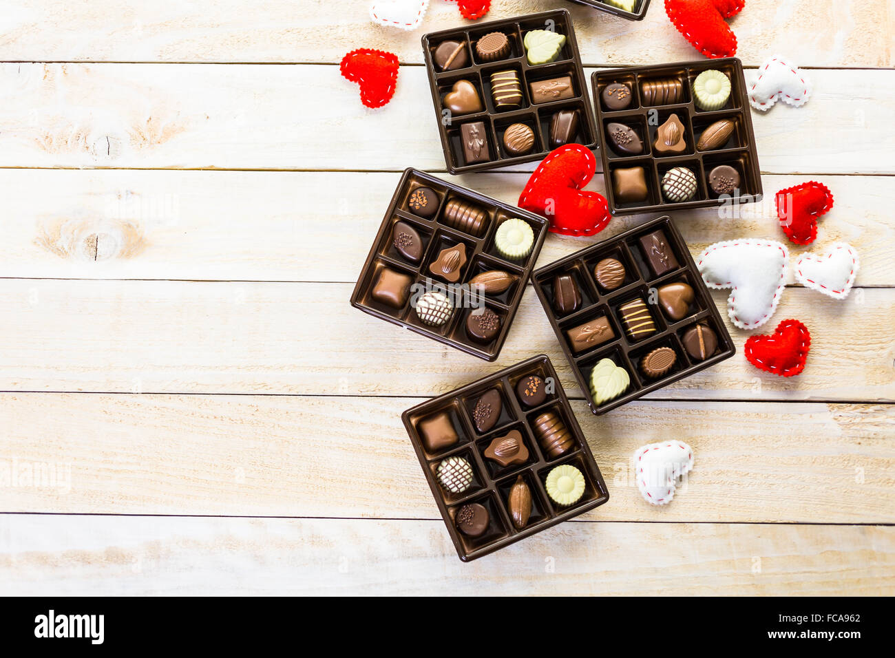 Assorted chocolates on wood table Stock Photo - Alamy