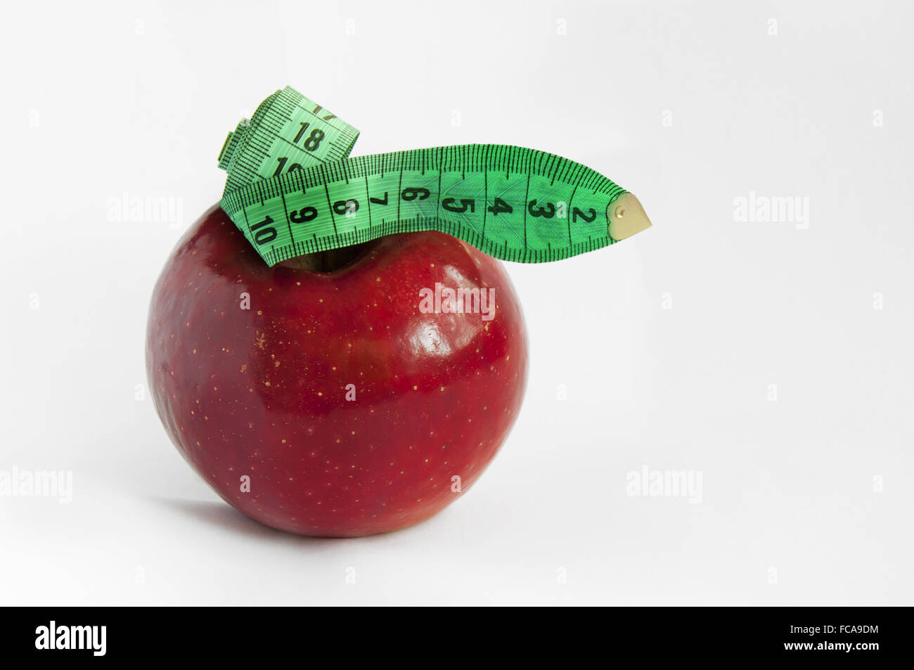 Green tape Measure with red Apple Stock Photo - Alamy