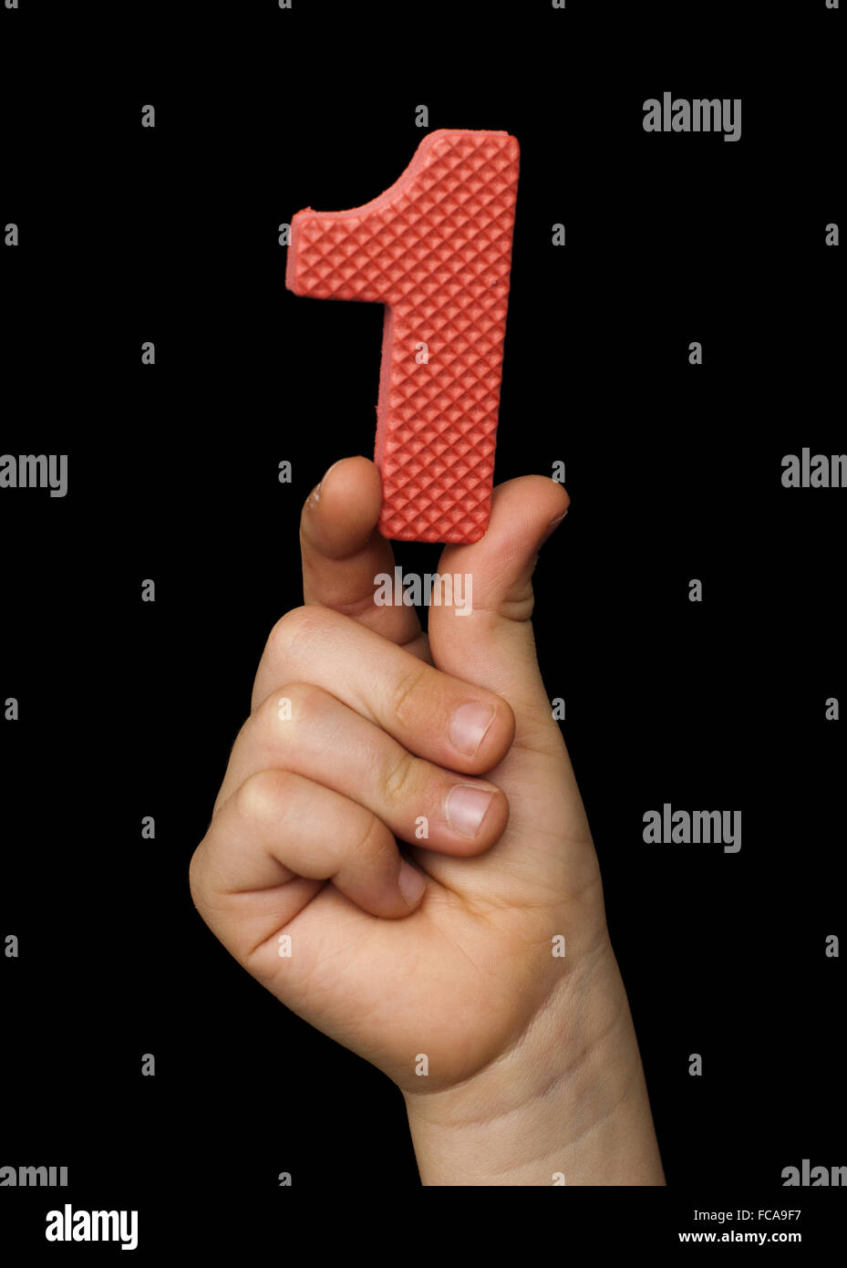 Children hand holding the number One Stock Photo - Alamy