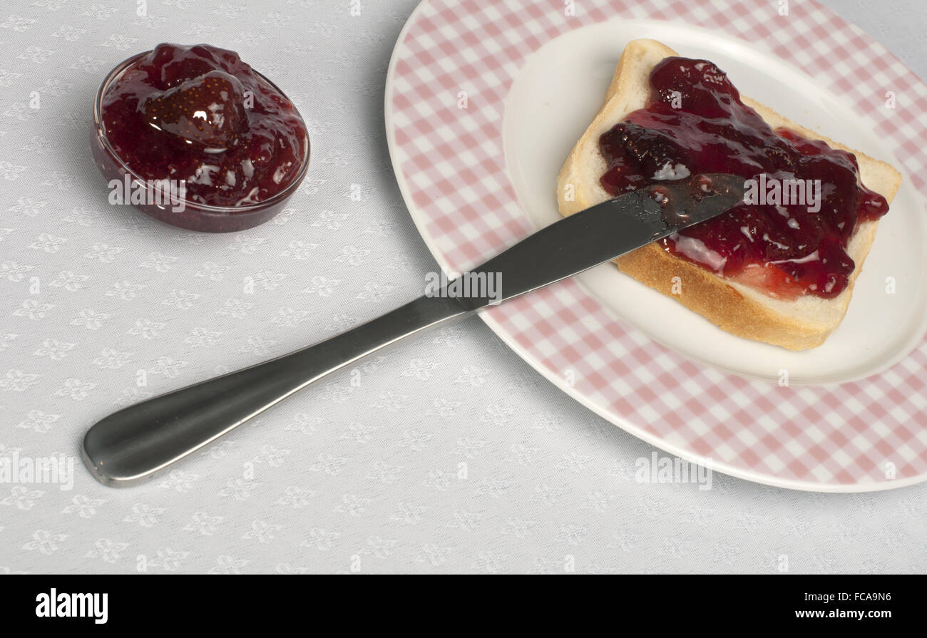 Spread jam on bread Stock Photo - Alamy