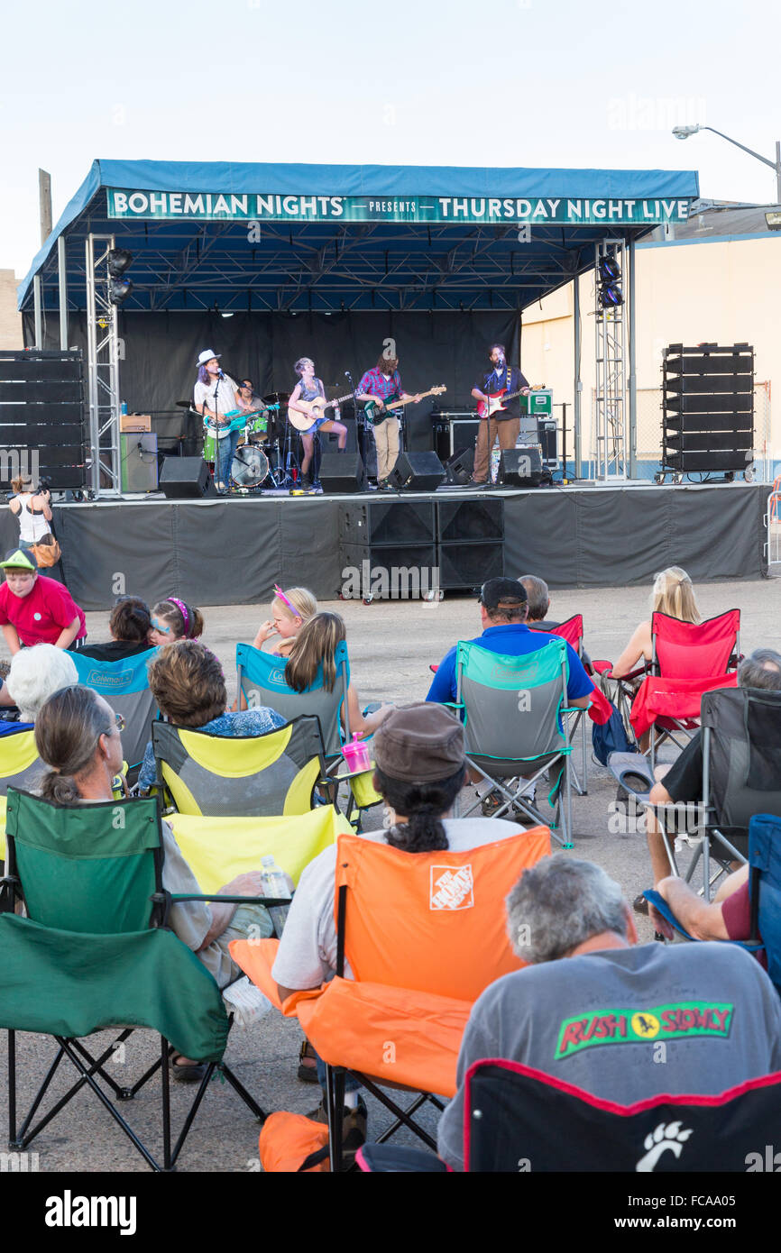 People gather to listen to a free concert during Bohemian Nights on ...