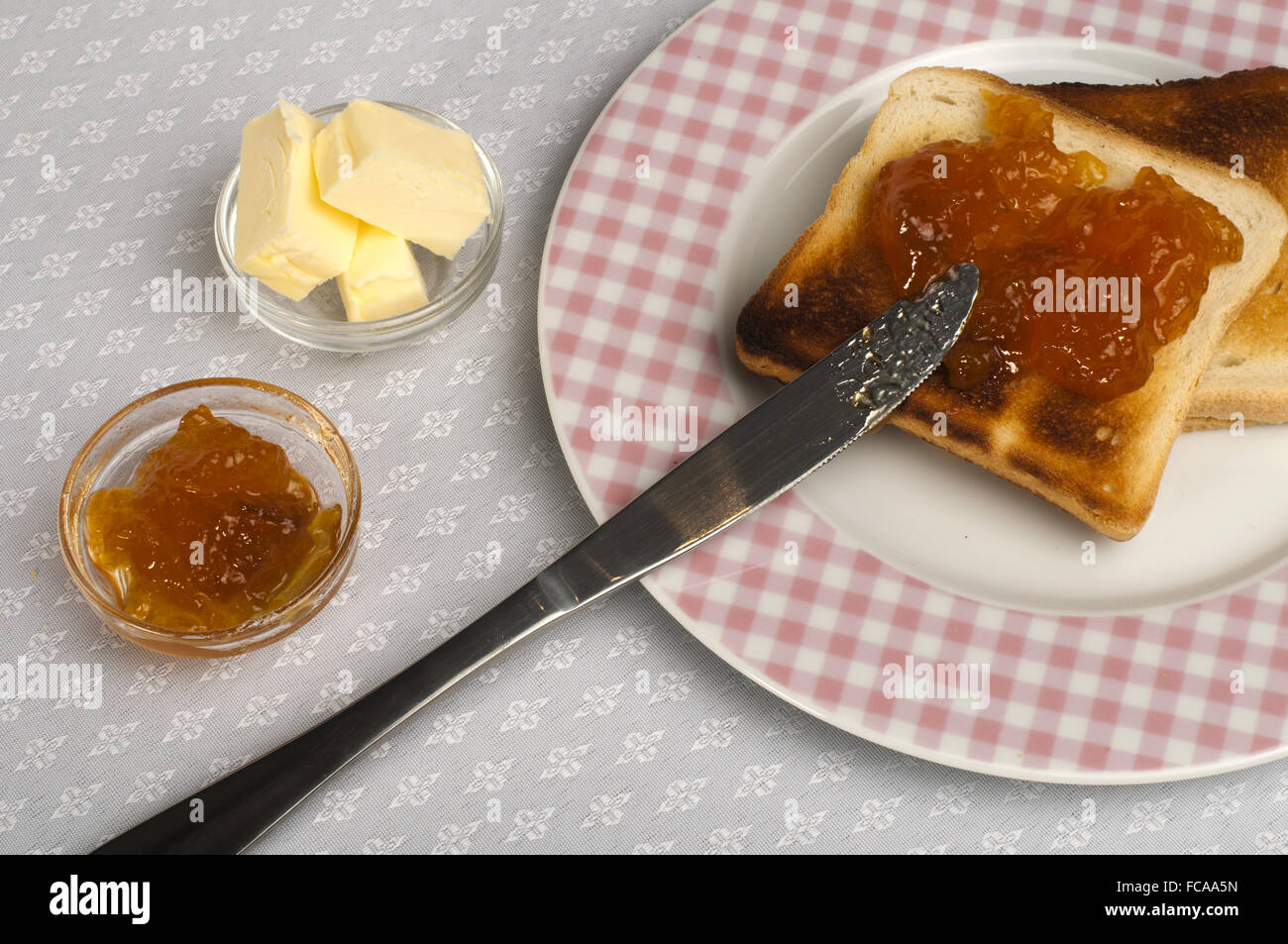 Spread jam on bread Stock Photo - Alamy