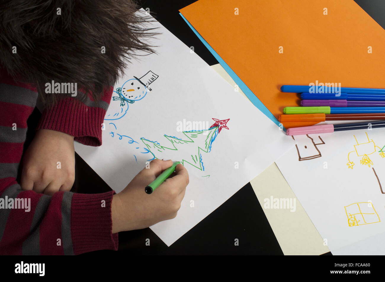Boy drawing with markers Stock Photo - Alamy