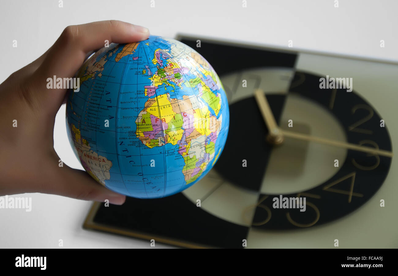 Globe and watch on background Stock Photo - Alamy