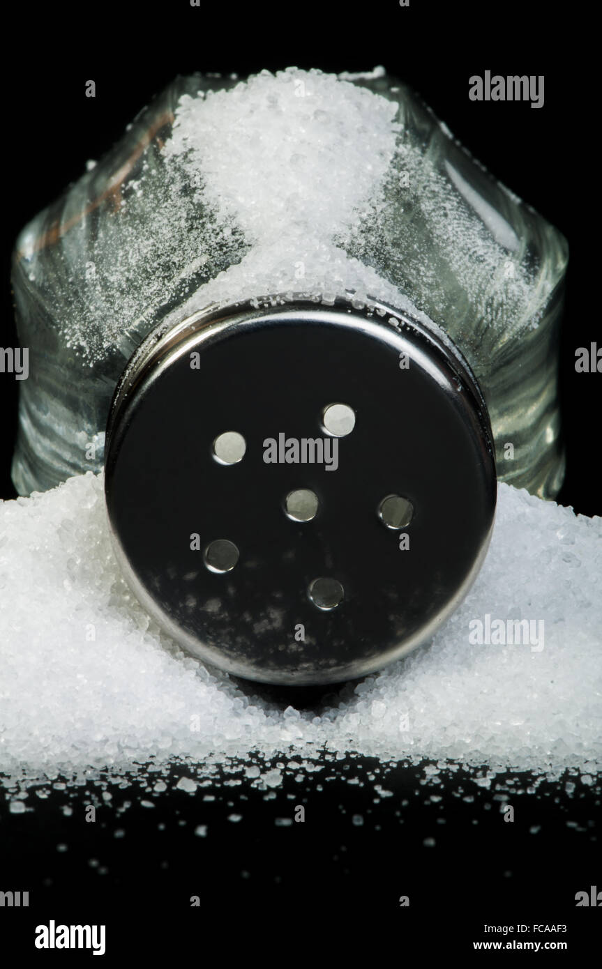 Salt on black background Stock Photo - Alamy